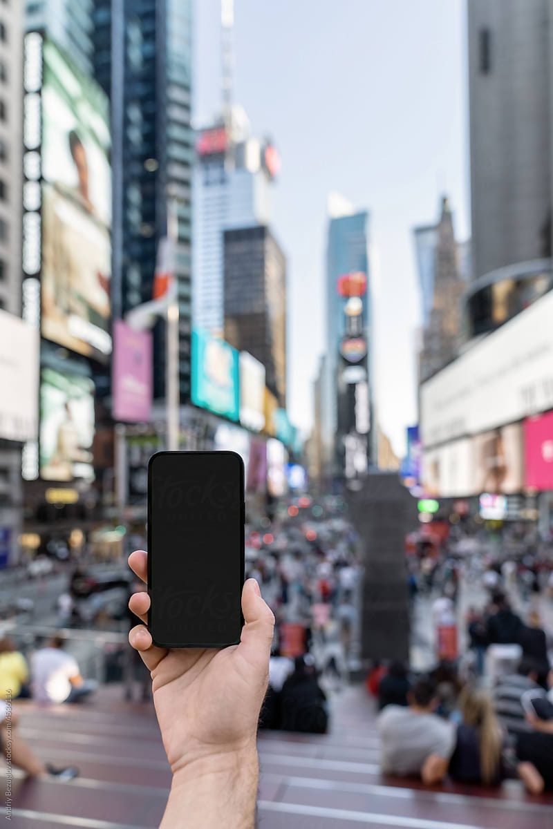 Guy is admiring view at Time Squares from steps - Stock Image - Everypixel
