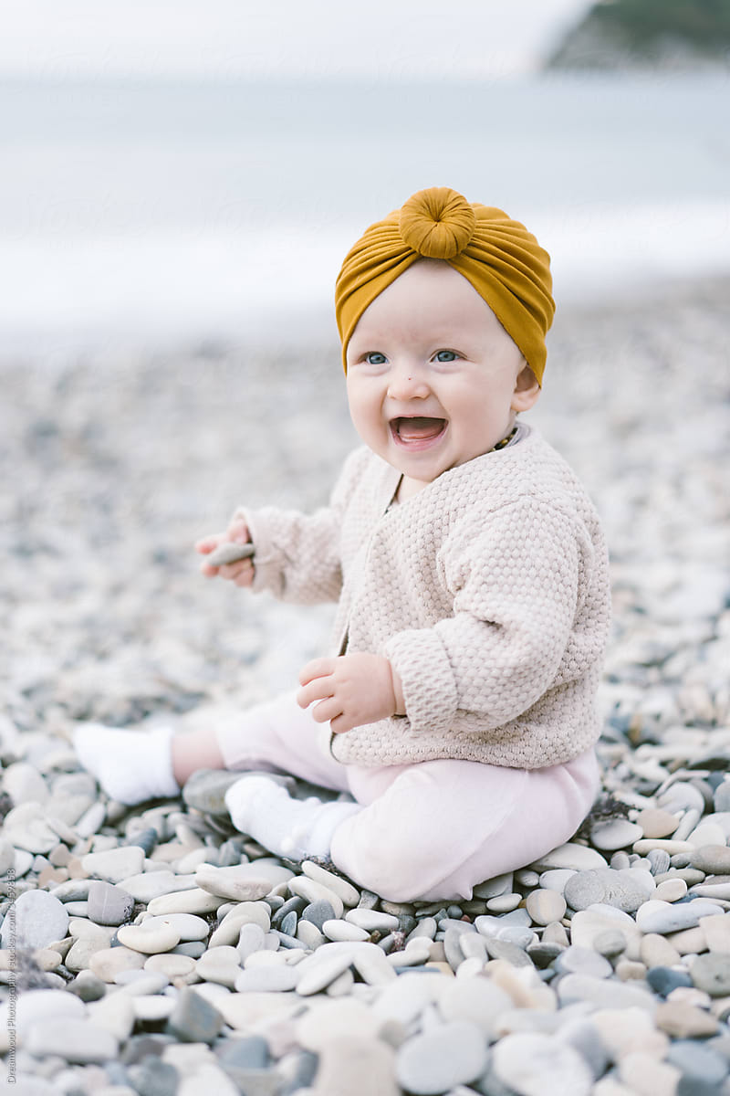"Happy Baby Playing With Stones Near Sea" by Stocksy Contributor ...