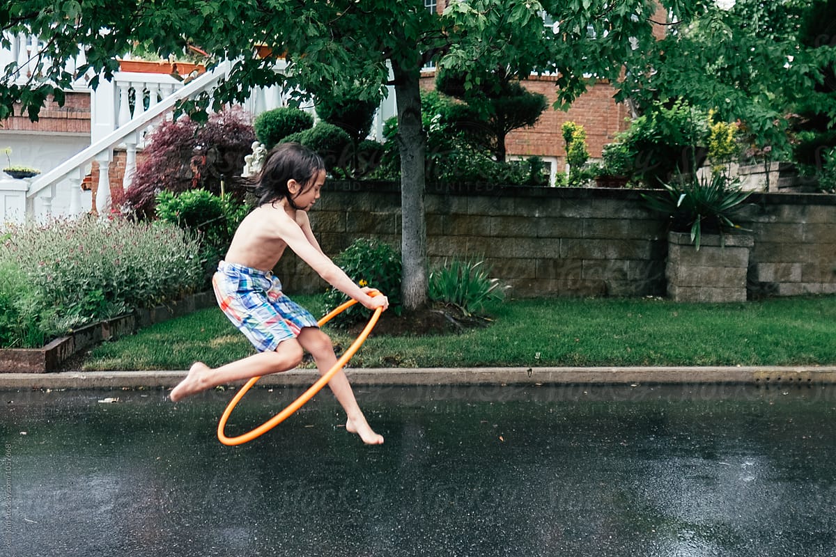 "Boy With Hula Hoop" by Stocksy Contributor "Kelli Seeger Kim" - Stocksy