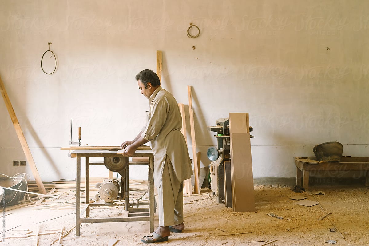 "Carpenter Working On Machine" by Stocksy Contributor "MaaHoo" - Stocksy