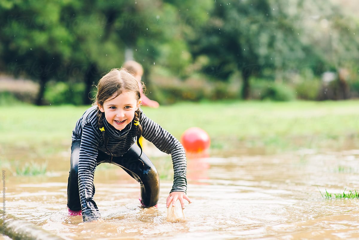 Little Girl Getting Up After Falling In A Big Puddle By Stocksy Little Girl Getting Up After Falling In A Big Puddle By Stocksy