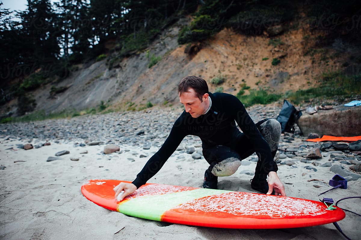 "Male Surfer Waxing His Surfboard" by Stocksy Contributor "Kristine ...