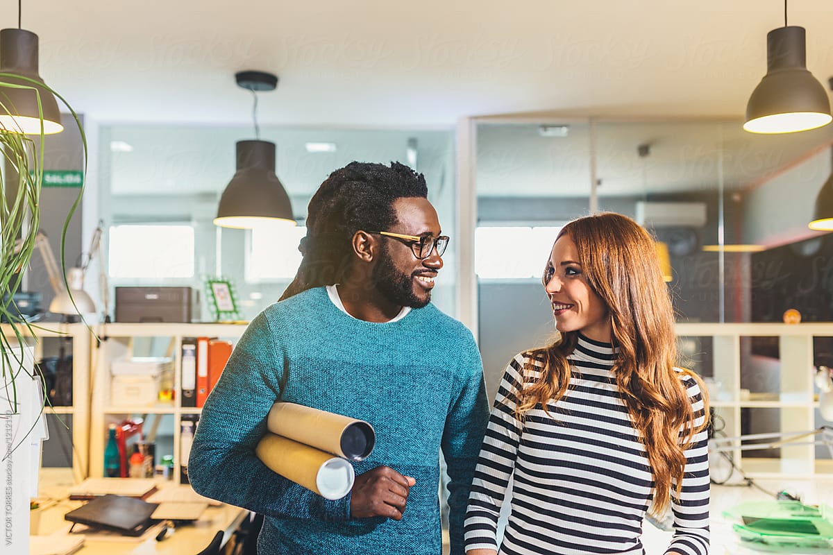"Friend Talk In Office" by Stocksy Contributor "VICTOR TORRES" - Stocksy