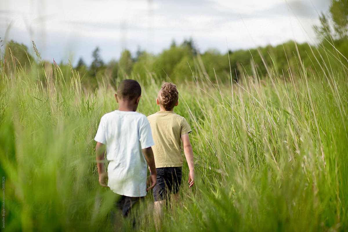 "Brothers Stride Through Field Of Tall Grass" by Stocksy Contributor ...