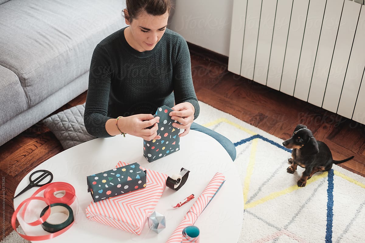 "Woman Wrapping Christmas Presents At Home" by Stocksy Contributor "B ...