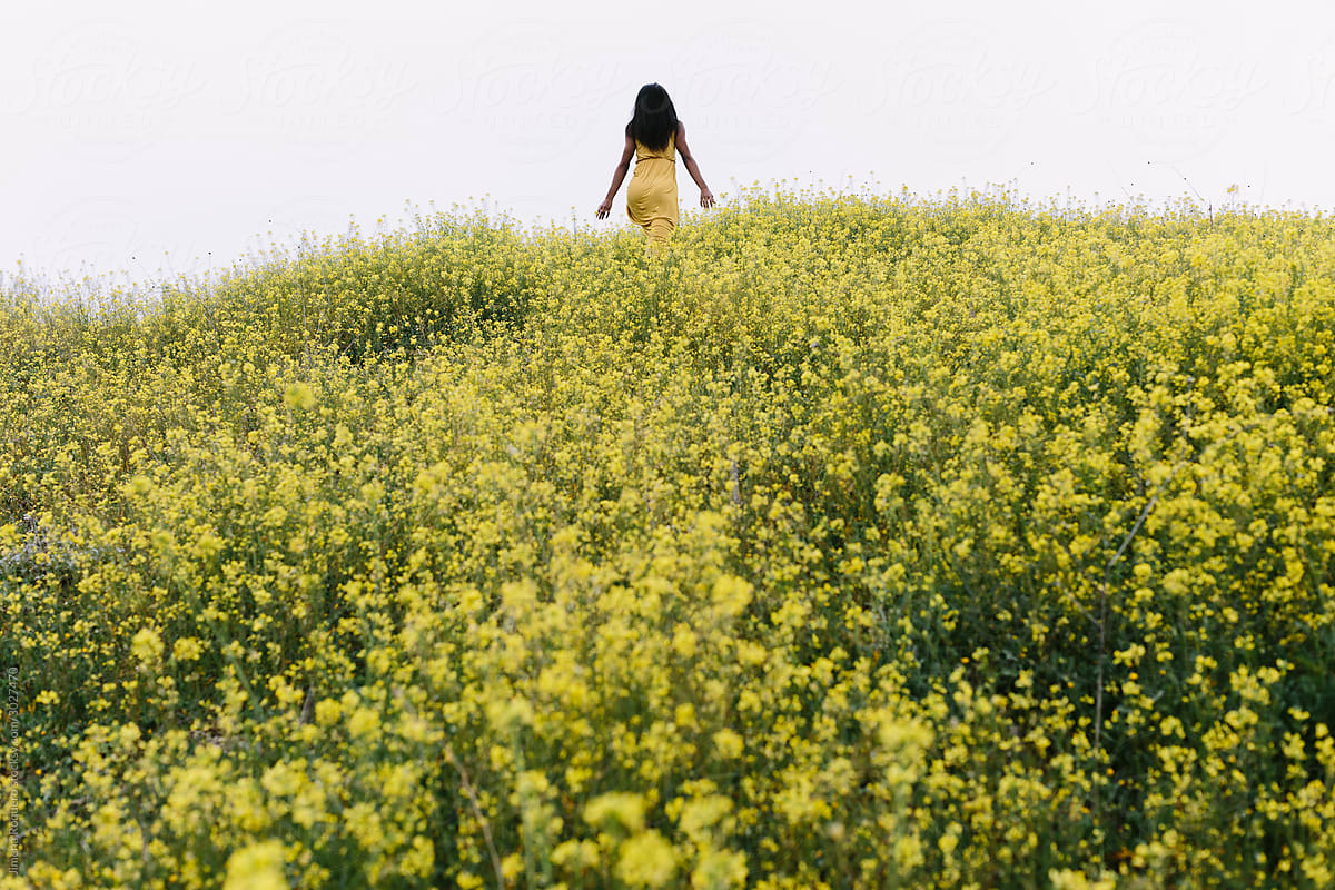 "Woman Climbing A Hill In Spring" by Stocksy Contributor "Jimena ...