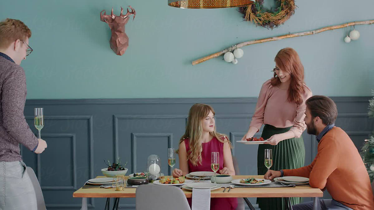 "Woman Serving Food At Dinner" by Stocksy Contributor "Lumina" - Stocksy
