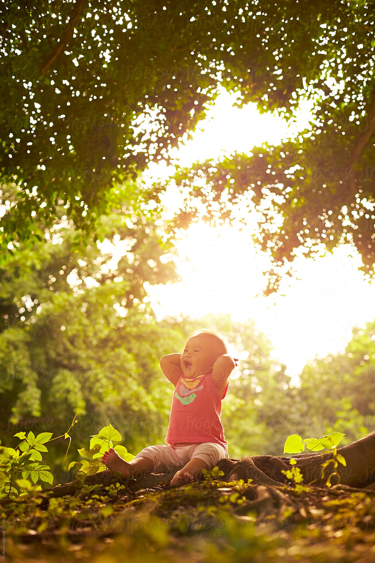 "Happy Baby Girl Sitting Under The Tree" by Stocksy Contributor "Bo Bo ...
