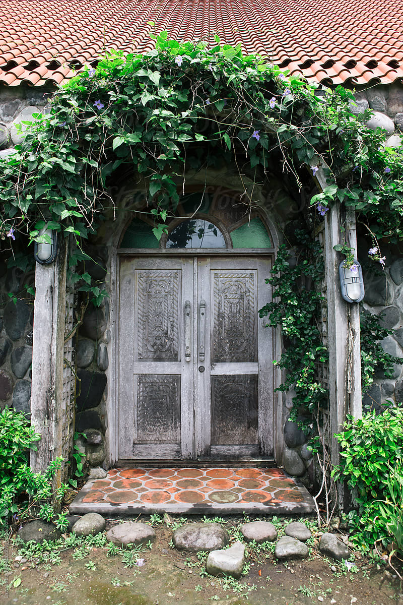 "Vines And Flowers Adorn A Wooden Door Side Entrance Of A Chapel On A ...