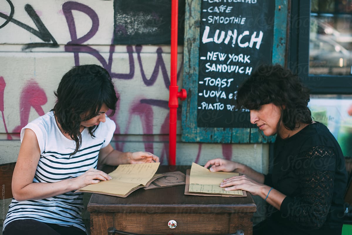 "Two Friends In A Restaurant" by Stocksy Contributor "Giada Canu" - Stocksy