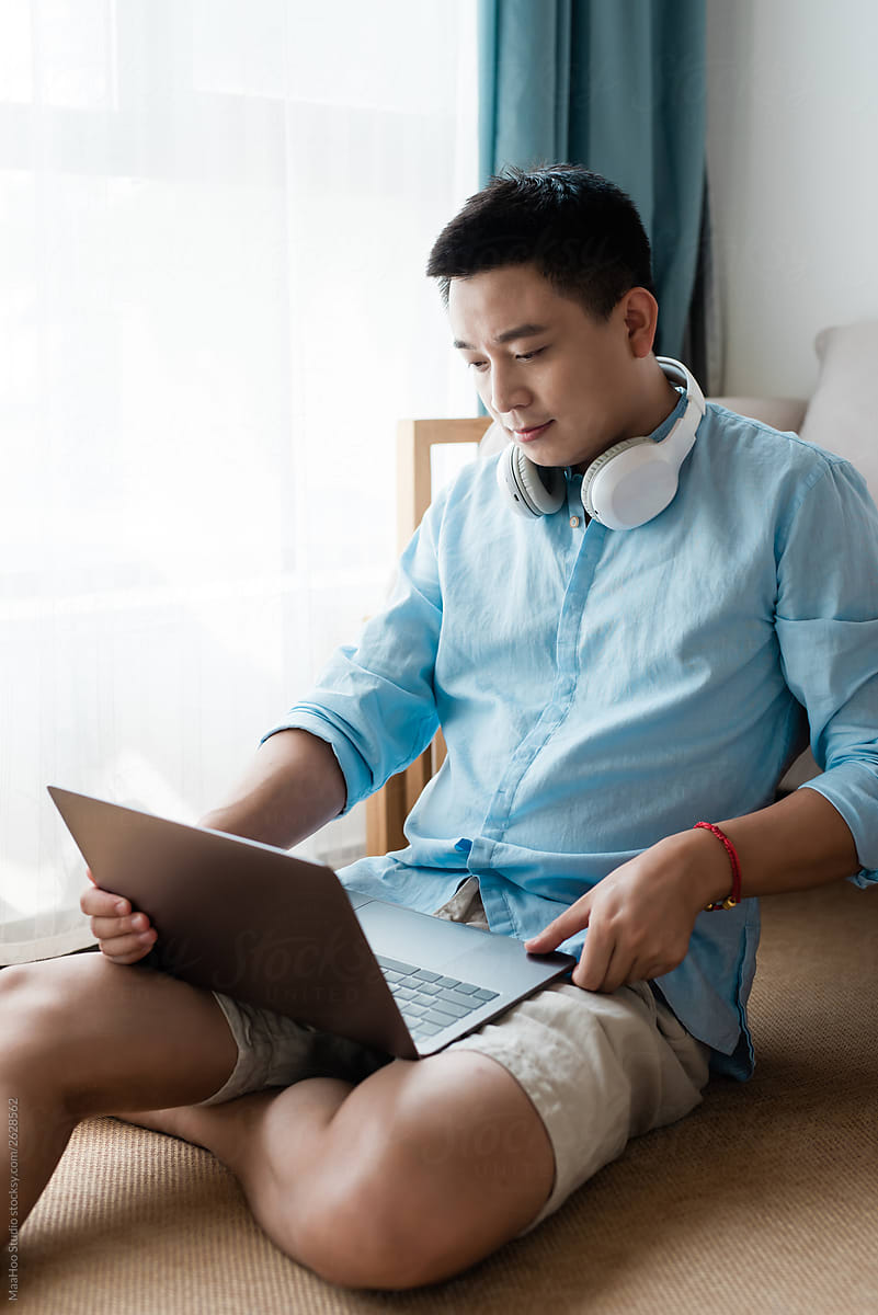 "Young Man Using Laptop At Home" by Stocksy Contributor "MaaHoo" - Stocksy