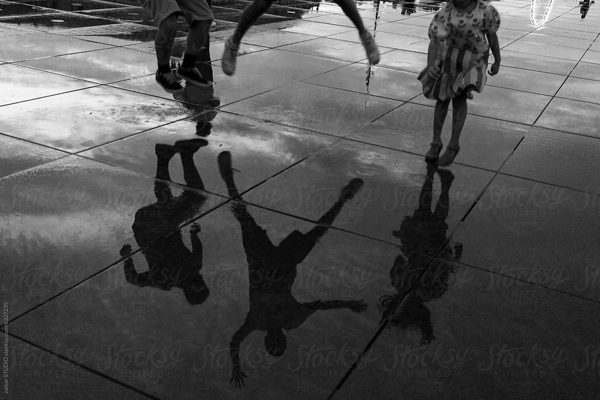 "Kids Jumping Reflection" by Stocksy Contributor "Valbar STUDIO" - Stocksy