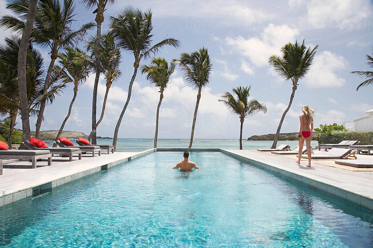 "Couple Relaxing At The Pool At Luxury Resort" by Stocksy Contributor ...