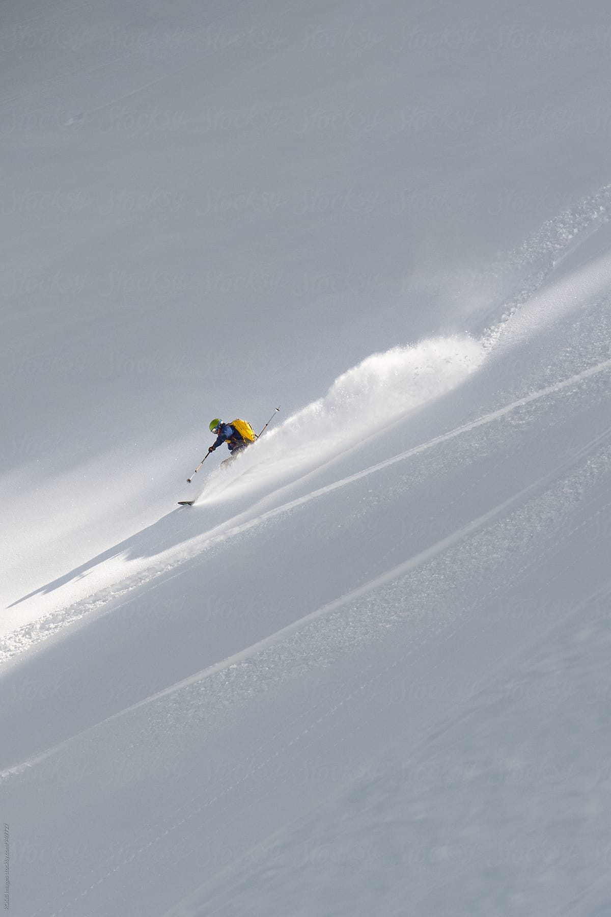 Skier riding downhill with speed splashing with snow - Stock Image ...