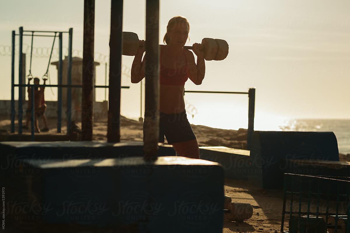 "Strong Woman Exercises On The Beach" by Stocksy Contributor "HOWL ...