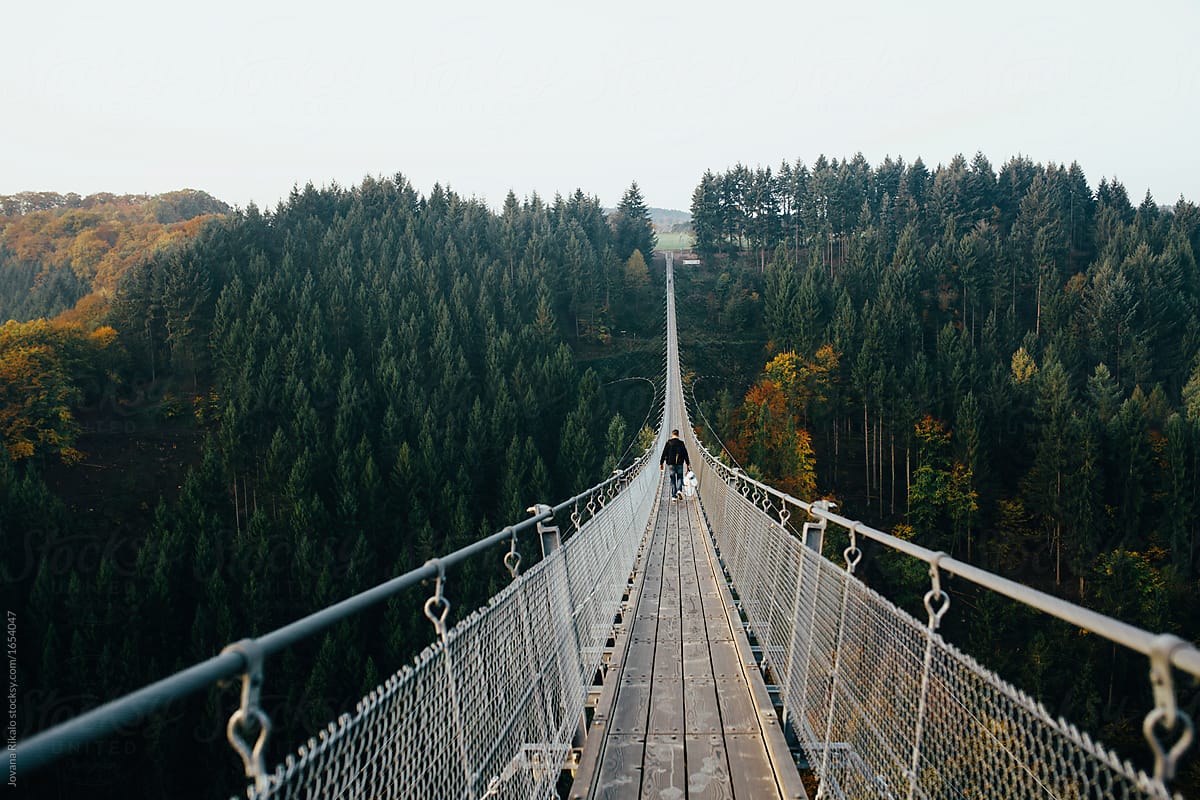 "Man Walking On A Long Bridge In Nature" by Stocksy Contributor "Jovana ...