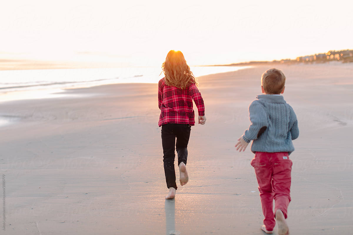 "Two Children Running Towards The Sun On A Beach" by Stocksy ...