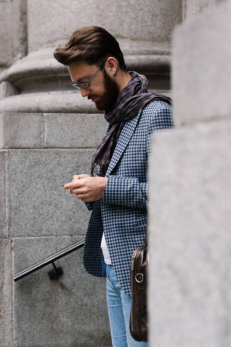 "Man Messaging" by Stocksy Contributor "Milles Studio" - Stocksy