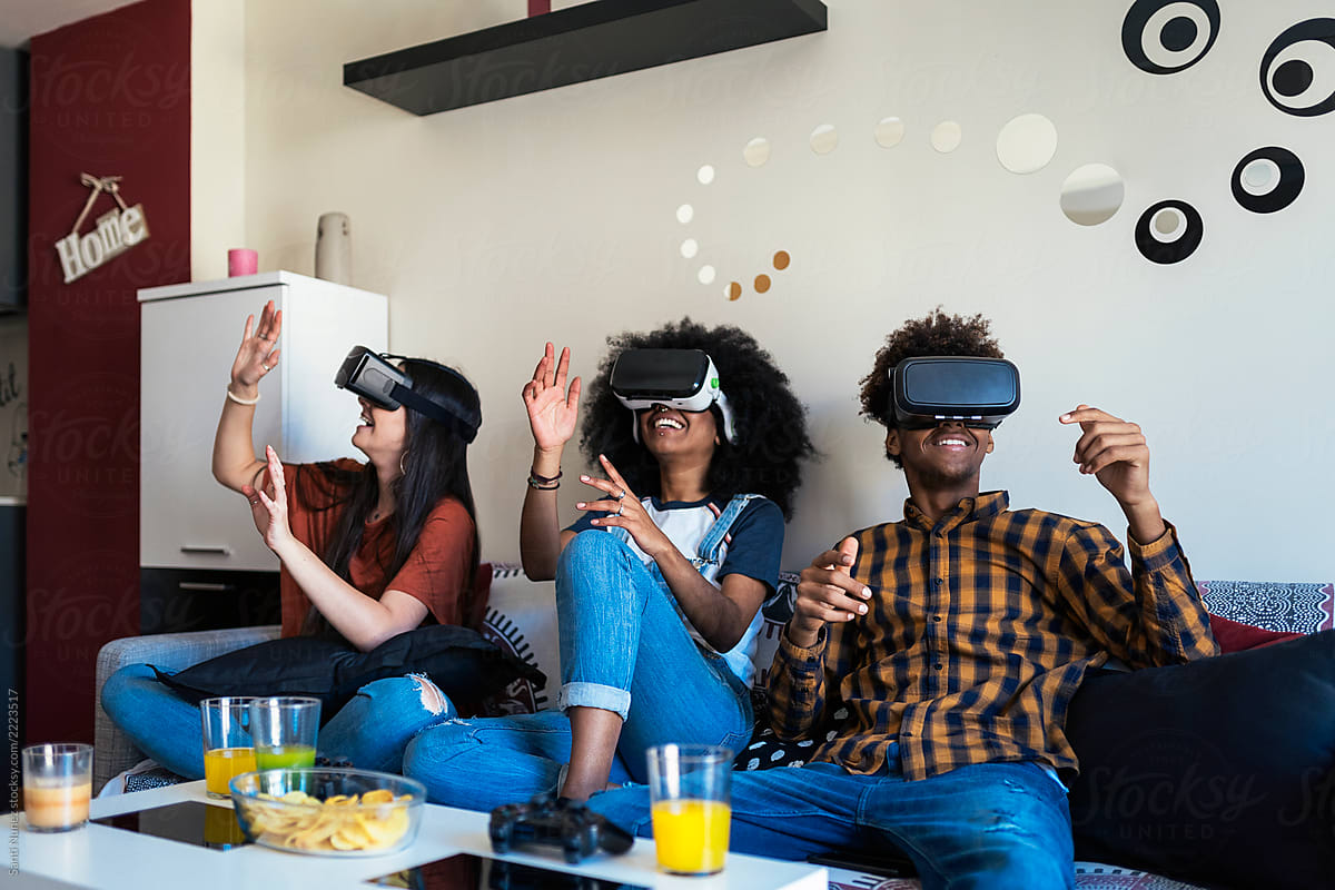  Group Of Happy Young Friends Playing Video Games At Home By Stocksy