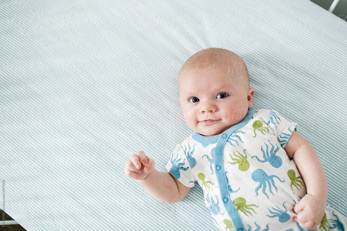 "Baby Laying In A Crib" by Stocksy Contributor "Kelly Knox" - Stocksy