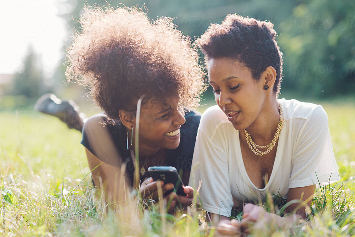 "Two Friends Relaxing Outdoors" by Stocksy Contributor "Vero." - Stocksy