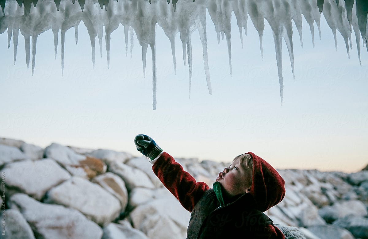 "Young Child Reaching For Icicle" by Stocksy Contributor "Raymond ...