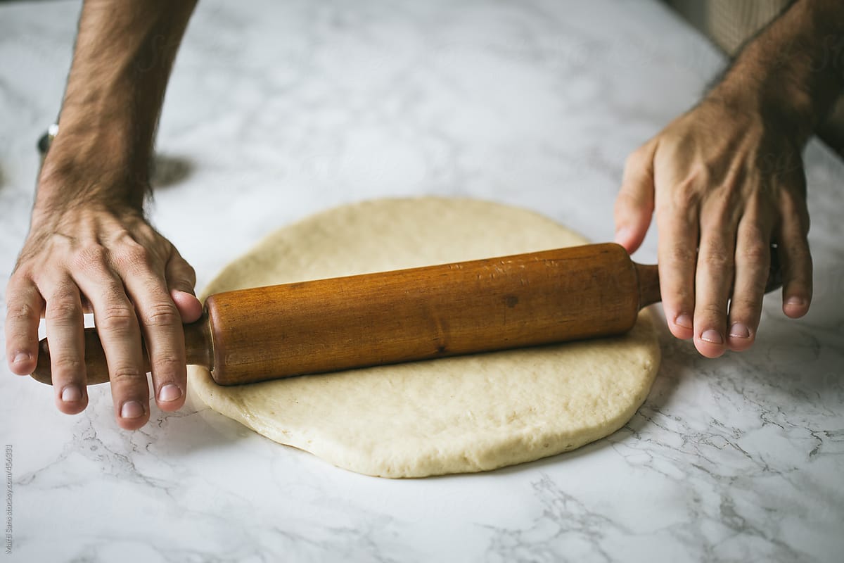 "Rolling Doughnuts Dough" by Stocksy Contributor "Martí Sans" - Stocksy