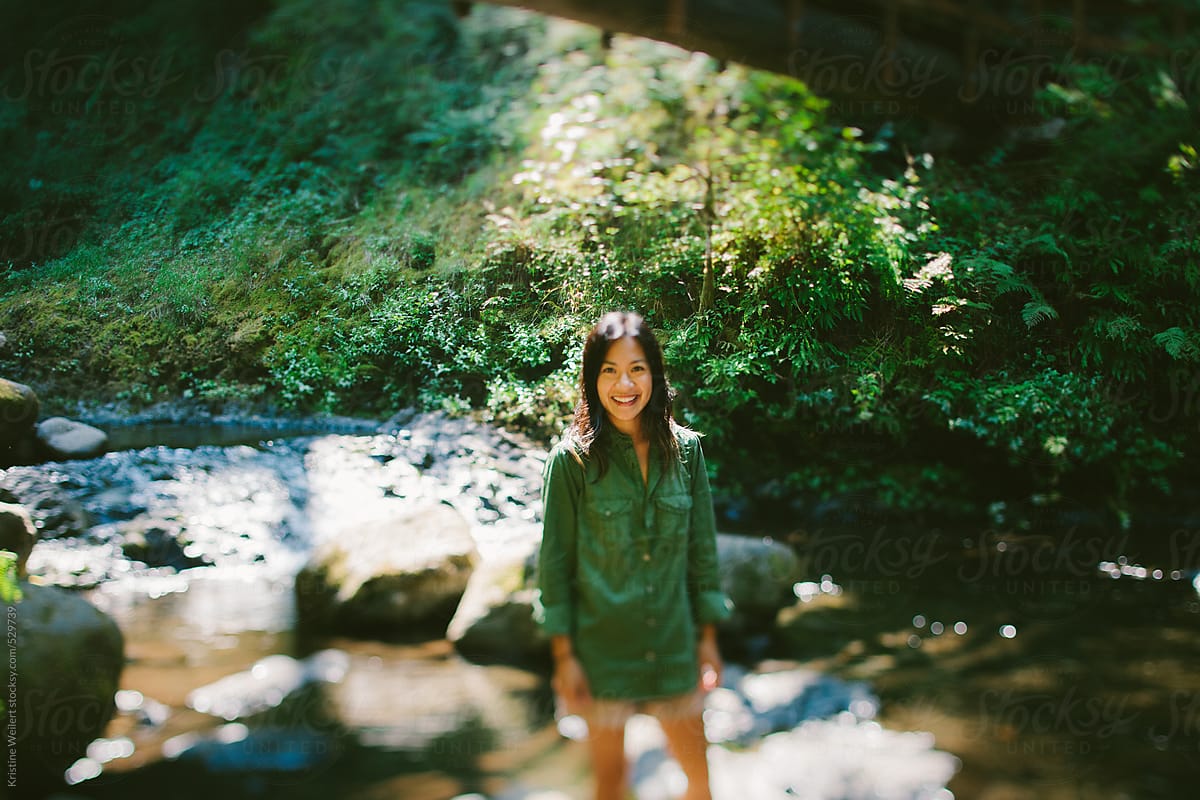 "Woman Smiling Surrounded By Beautiful Forest And Water" by Stocksy ...