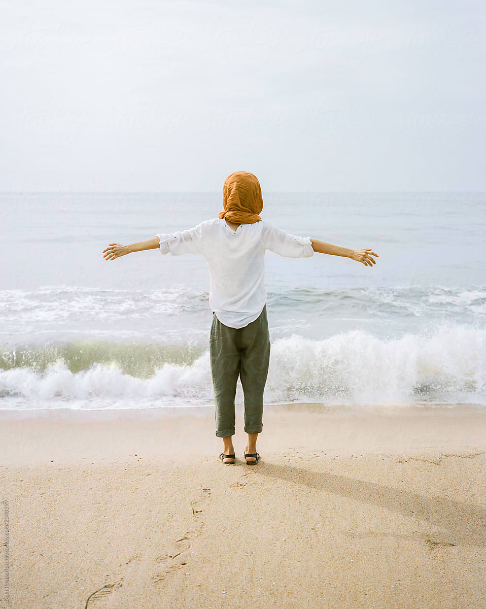 "Woman Enjoying Ocean Waves On Beach" by Stocksy Contributor "Duet ...
