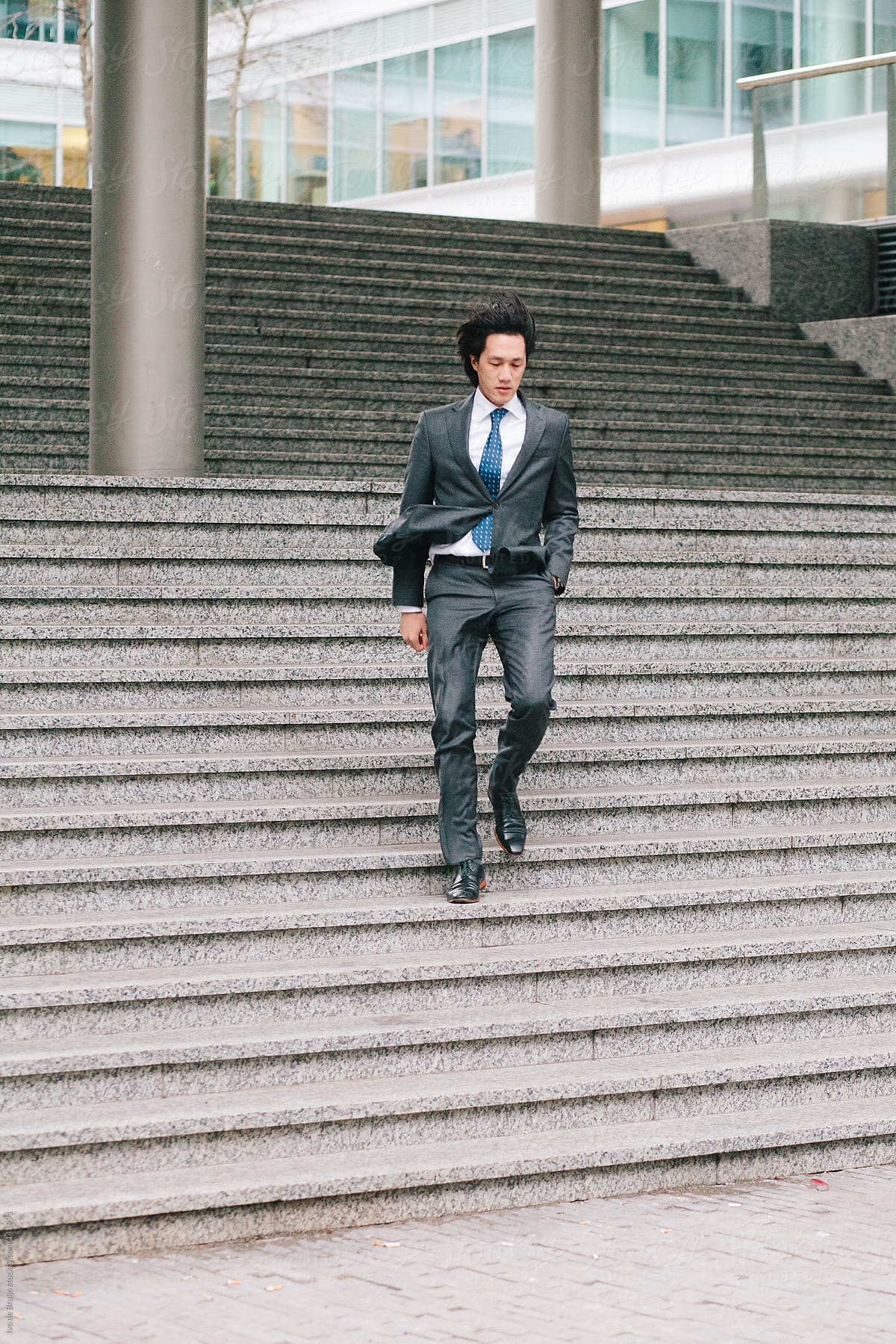 "Ambitious Asian Young Businessman Running Down The Stairs" by Stocksy ...