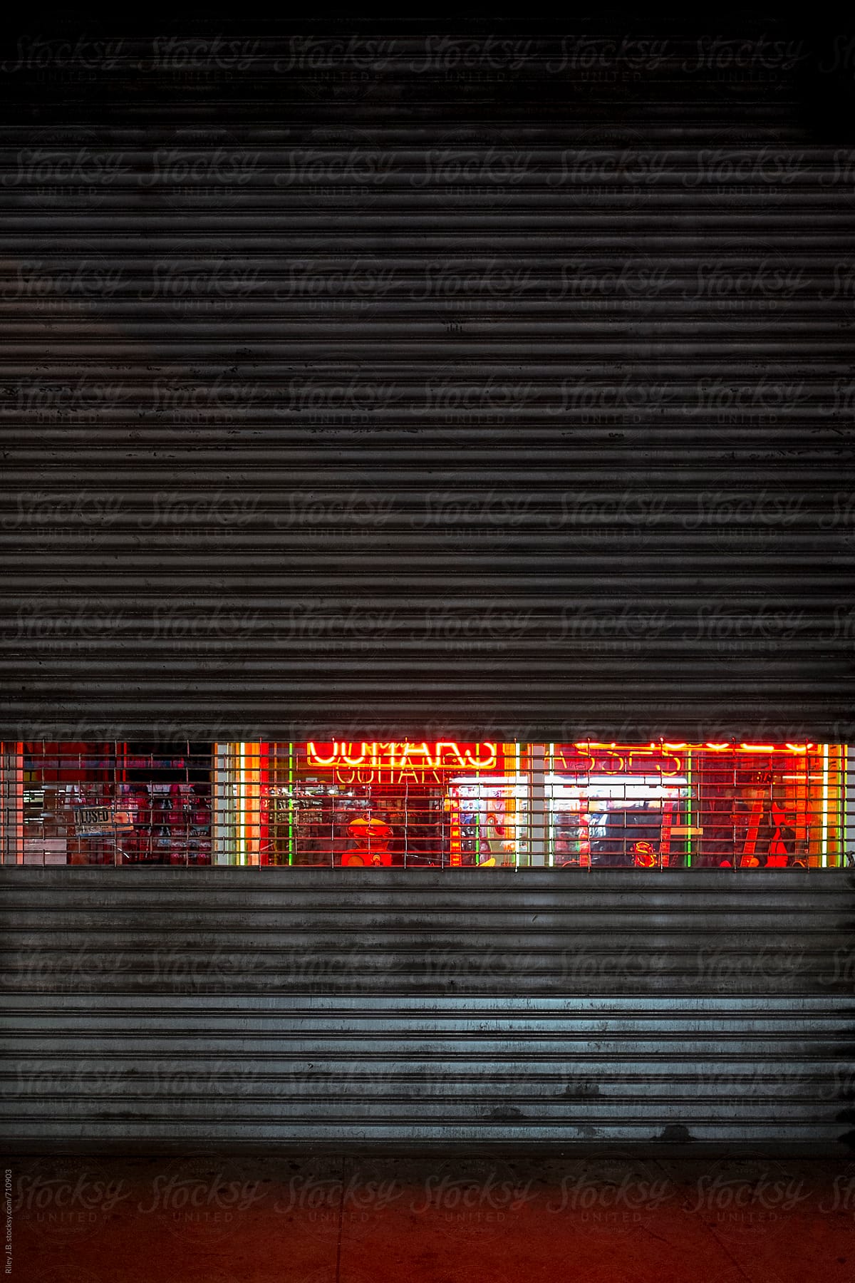 "Neon Leaks Through A Security Shutter At Guitar Store" by Stocksy ...