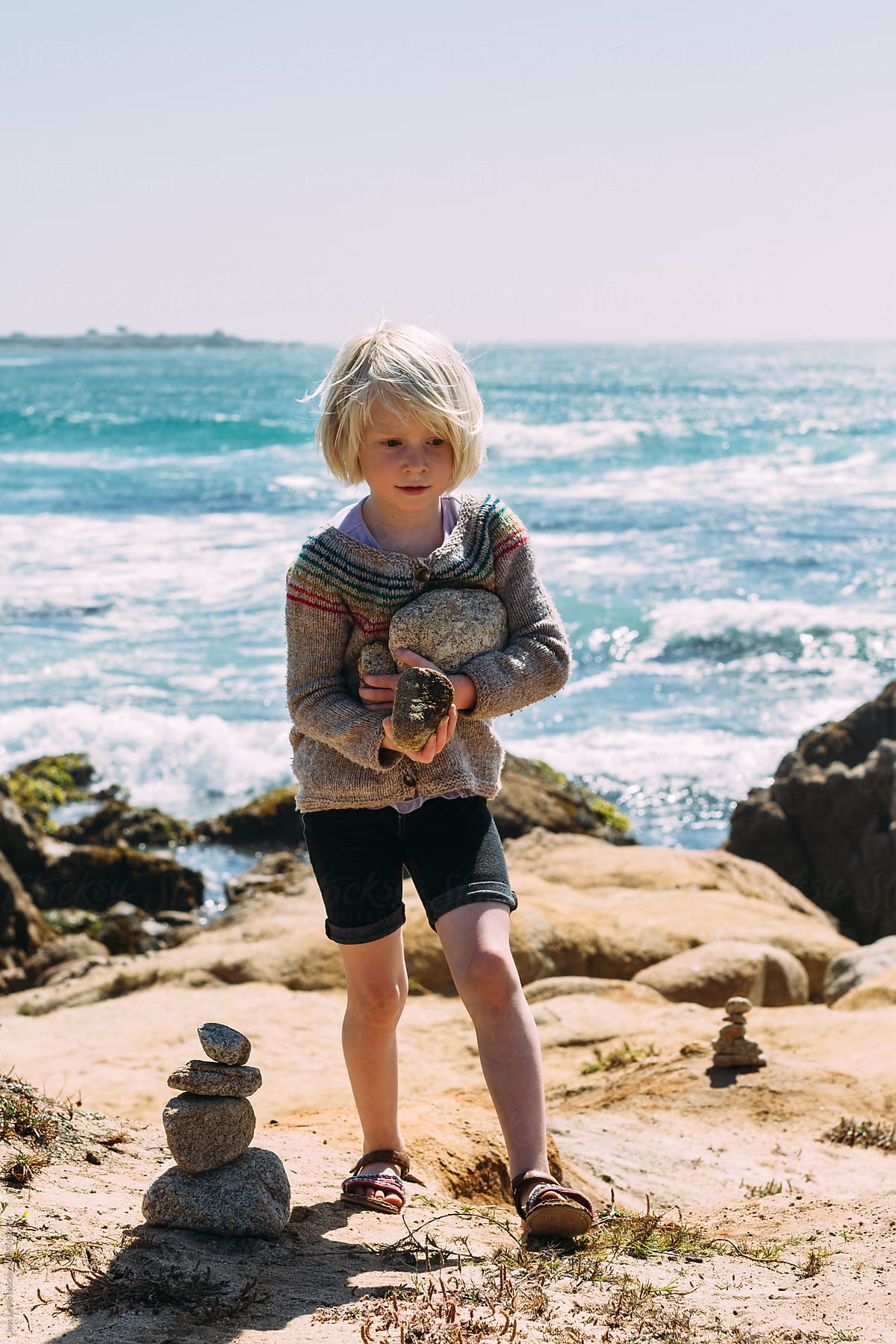 "Cute Girl Carrying Stones For Stacking" by Stocksy Contributor "Jess ...