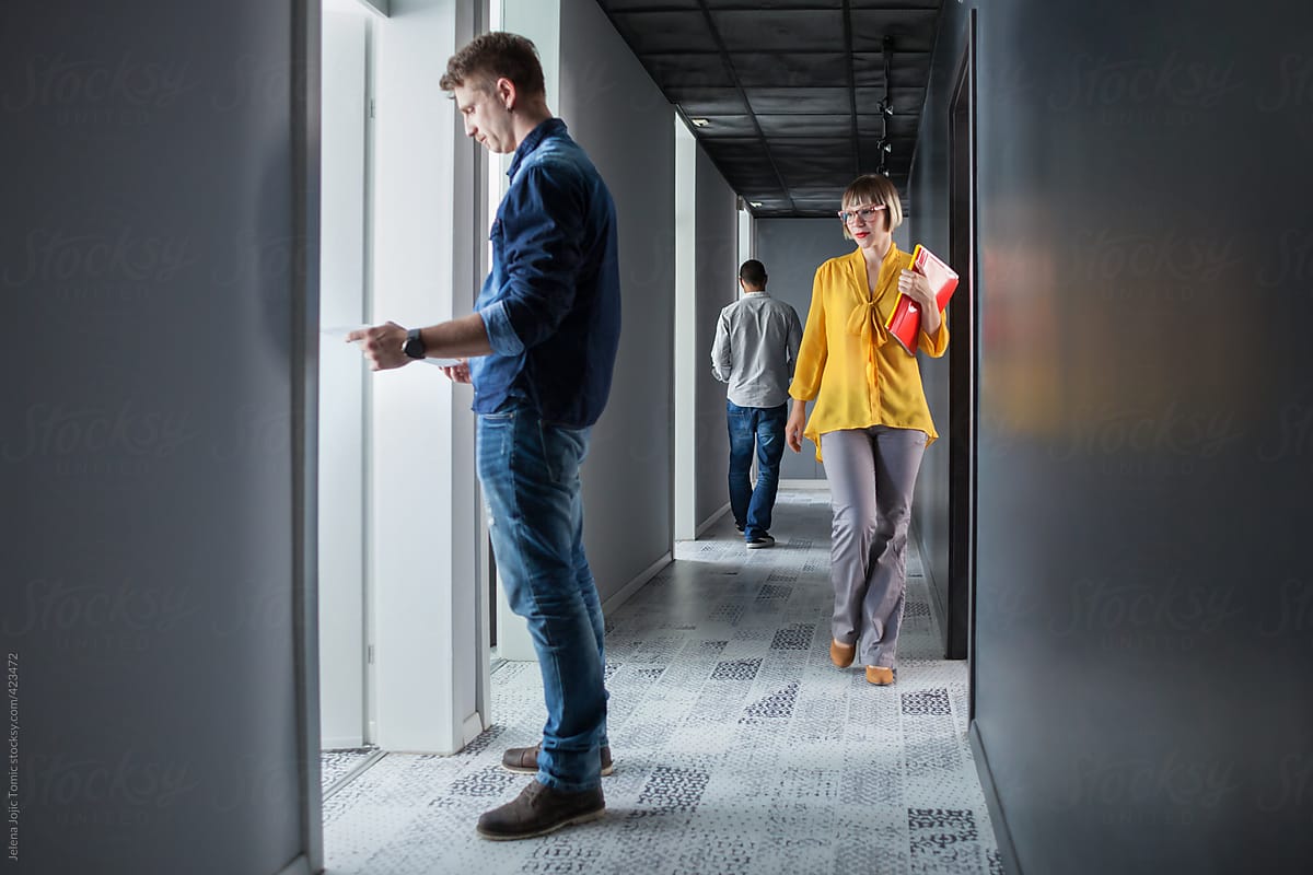 "People In The Hallway Of The Company" by Stocksy Contributor "Jelena ...