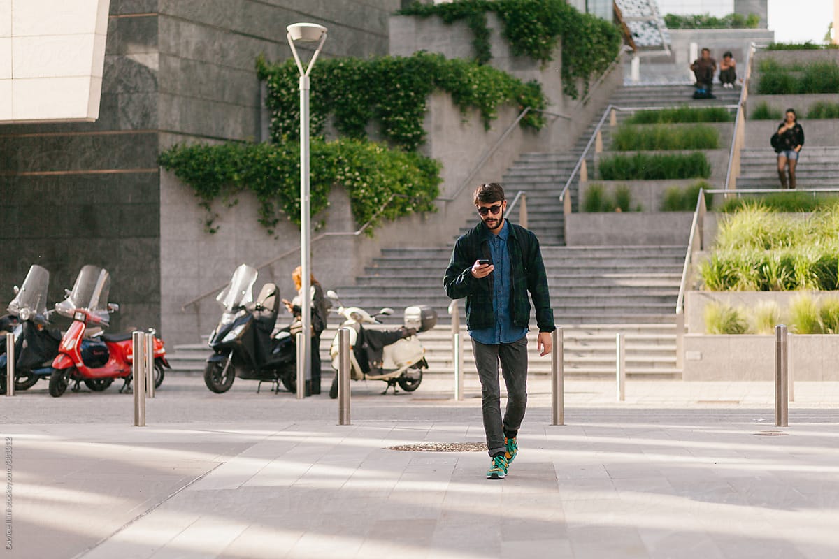 "Young Man Walking And Typing At His Cellphone" by Stocksy Contributor ...