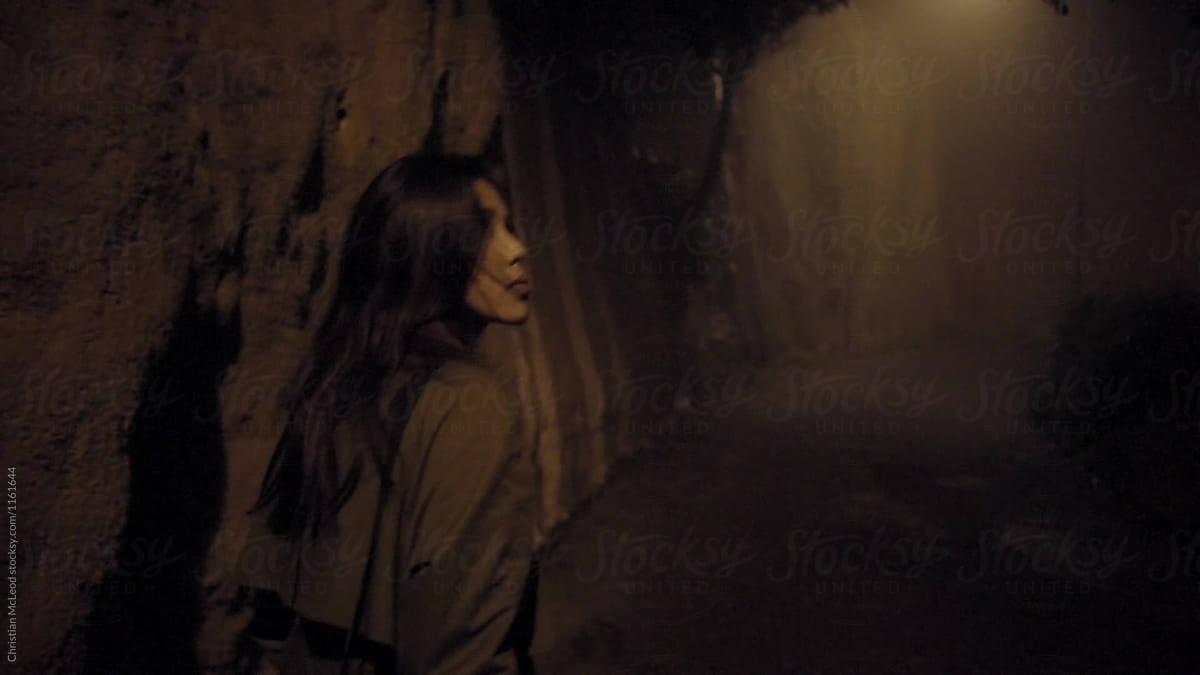 "Young Woman Walks Down A Dark Street At Night" by Stocksy Contributor ...