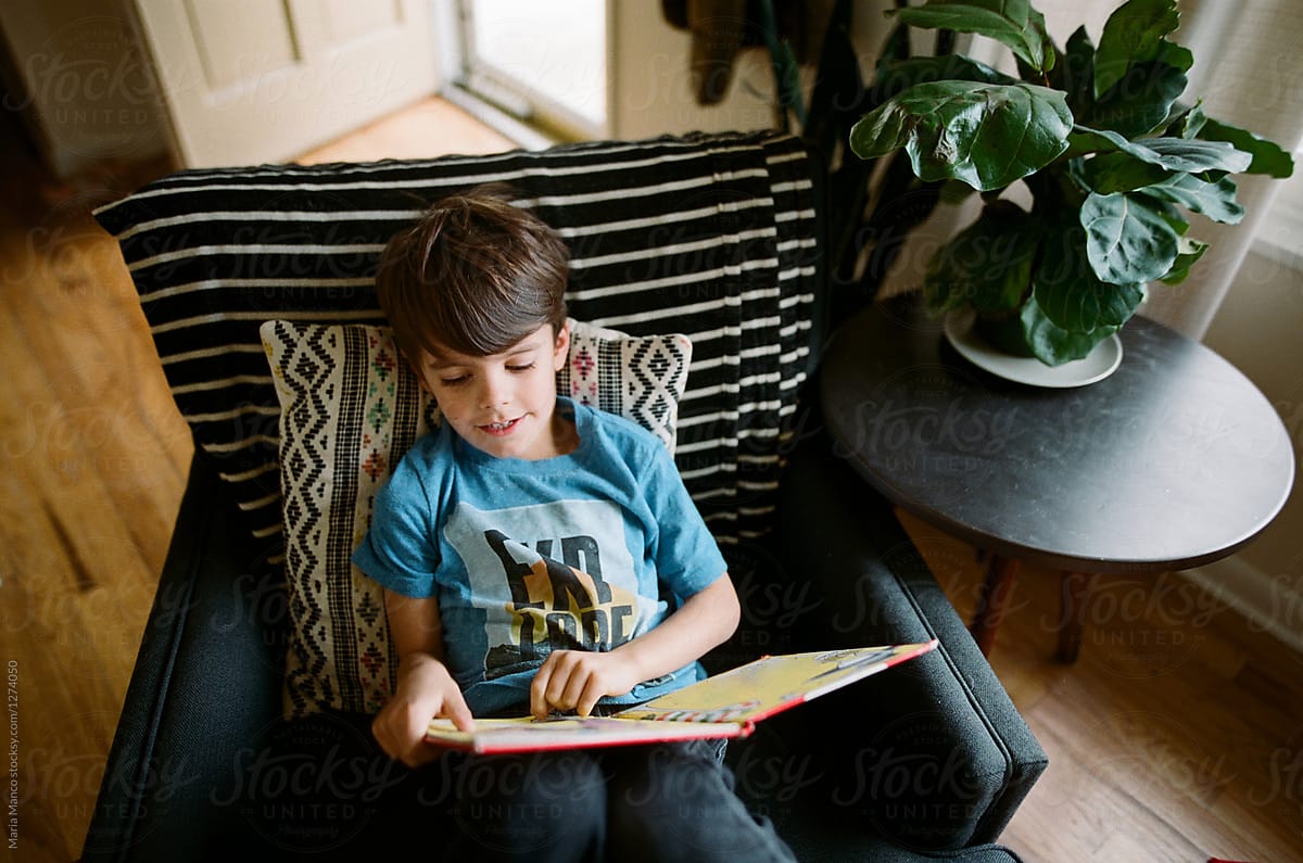 "Overhead View Of Boy Reading" by Stocksy Contributor "Maria Manco ...