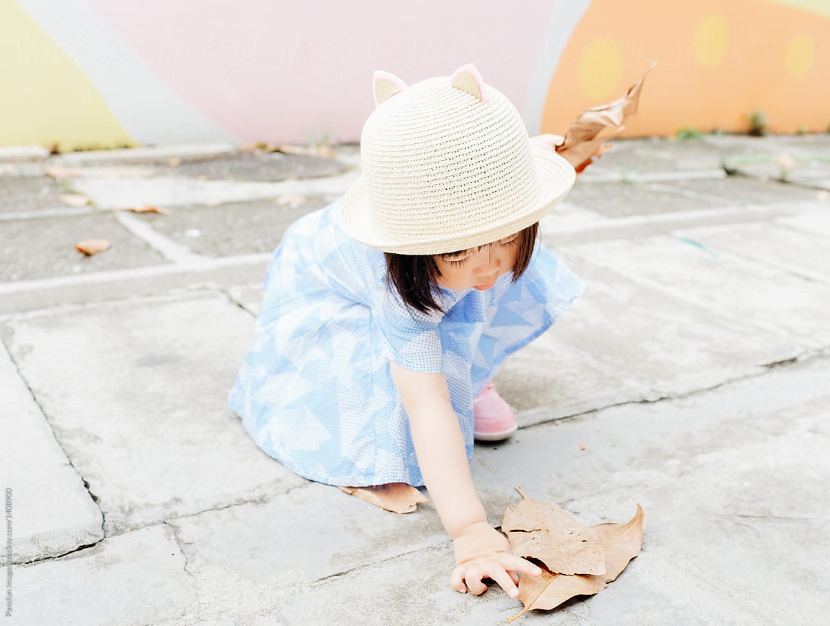"Asian Little Girl Picking Up Fallen Leaves" by Stocksy Contributor ...