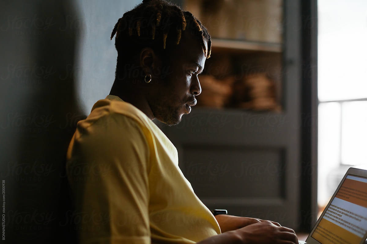 "Man Using His Laptop." by Stocksy Contributor "BONNINSTUDIO " - Stocksy