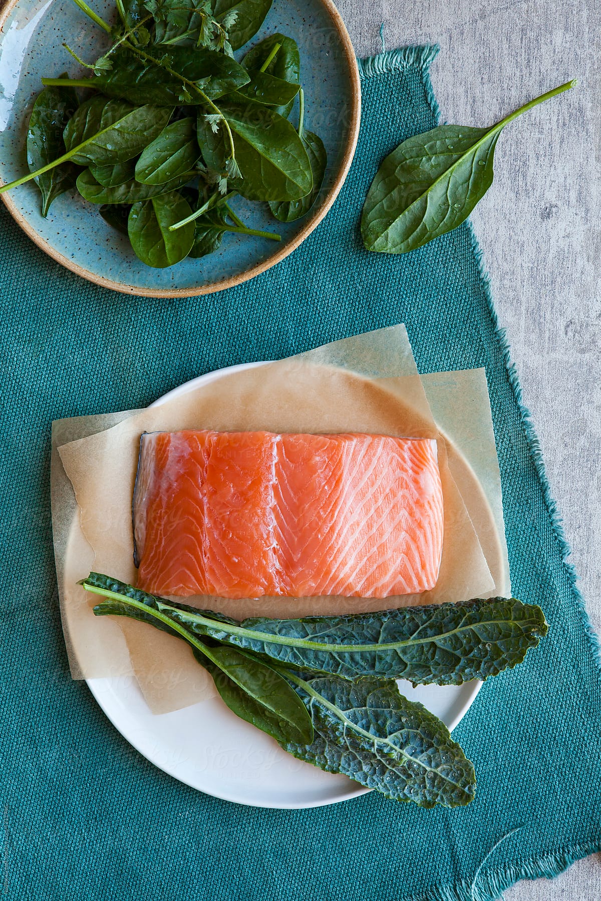 Raw Salmon Fish With Greens By Stocksy Contributor Nadine Greeff Raw Salmon Fish With Greens By Stocksy Contributor Nadine Greeff