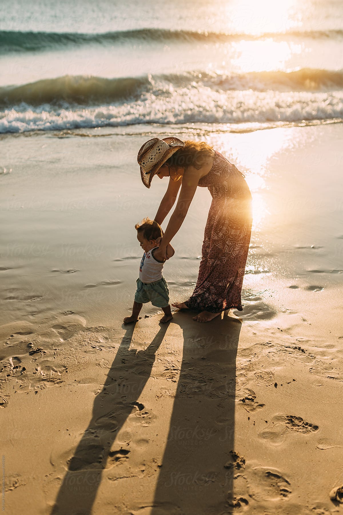 "Mother Helping Her Baby In His First Steps" by Stocksy Contributor ...