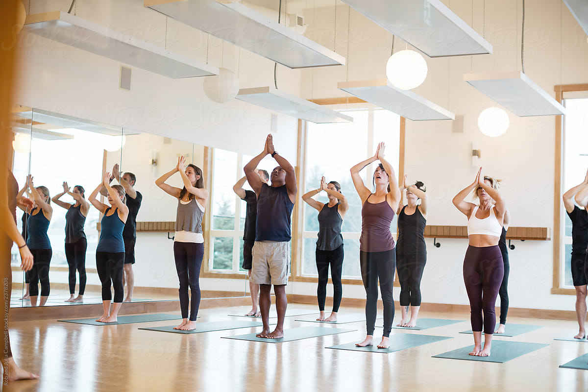"Yoga Instructor Teaching A Class" by Stocksy Contributor "Rob and ...