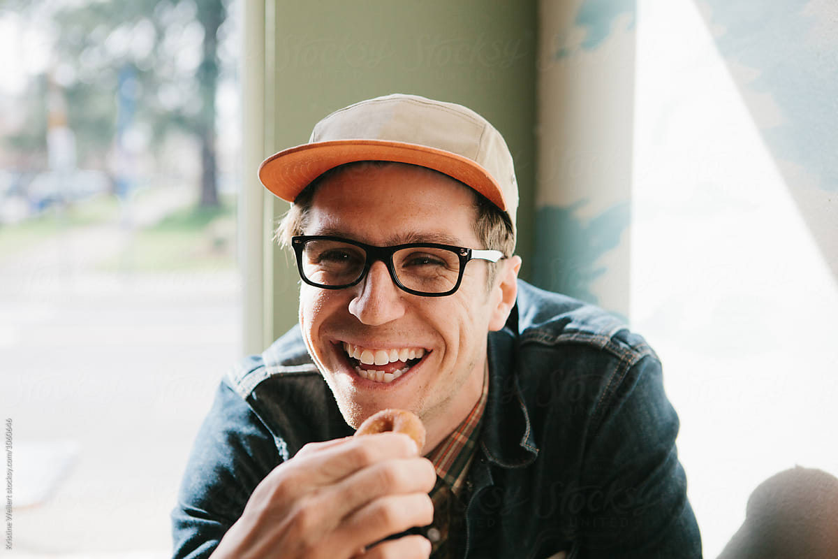"Man Excited About Mini Donuts" by Stocksy Contributor "Kristine ...