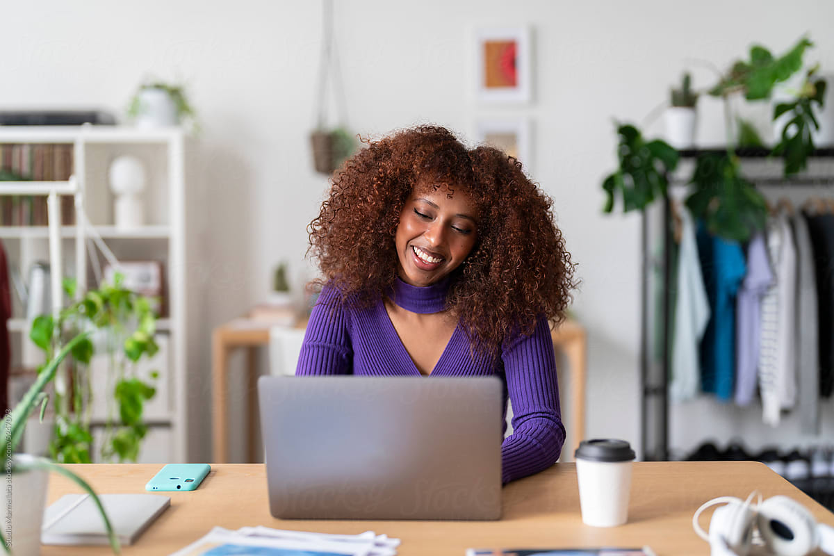 "Smiling Eritrean Woman Browsing Computer In Apartment" by Stocksy ...