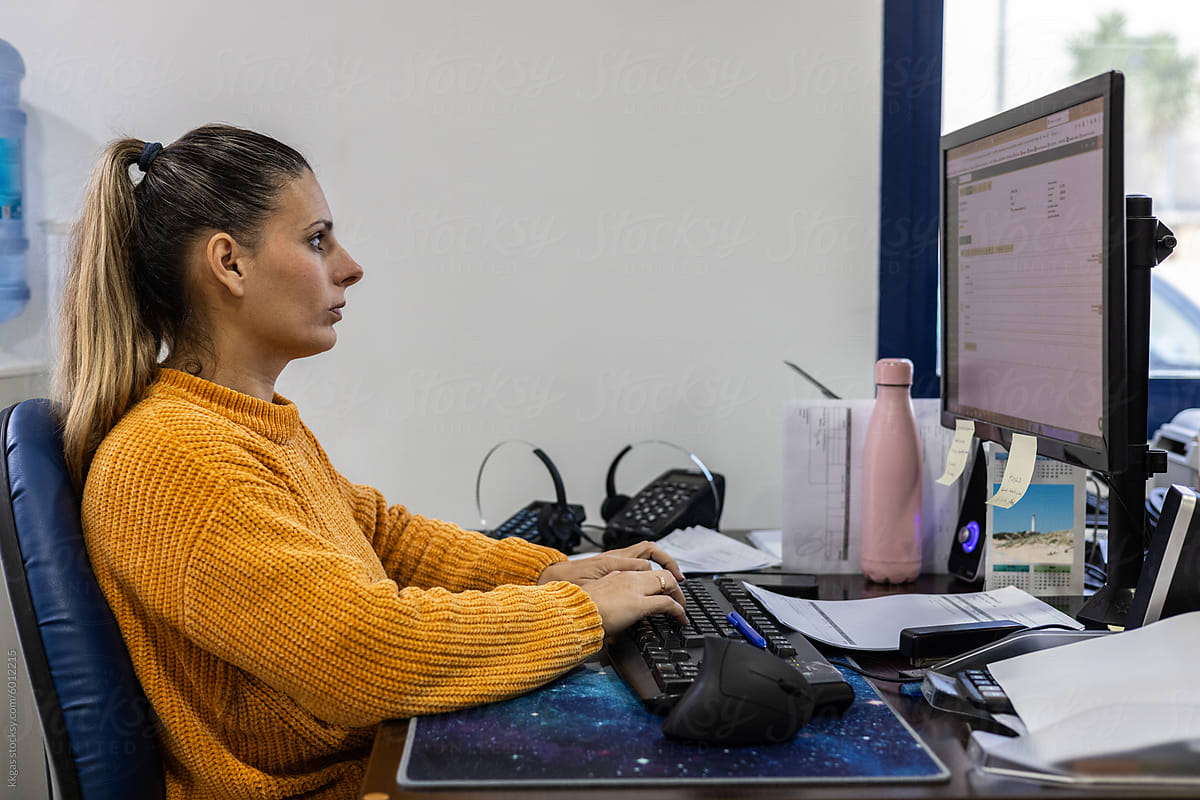 "An Office Worker At Her Desk" by Stocksy Contributor "kkgas" - Stocksy