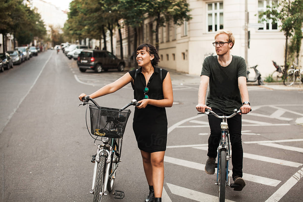 "Stroll And Talk: Friends On Bikes In The Summer Evening" by Stocksy ...