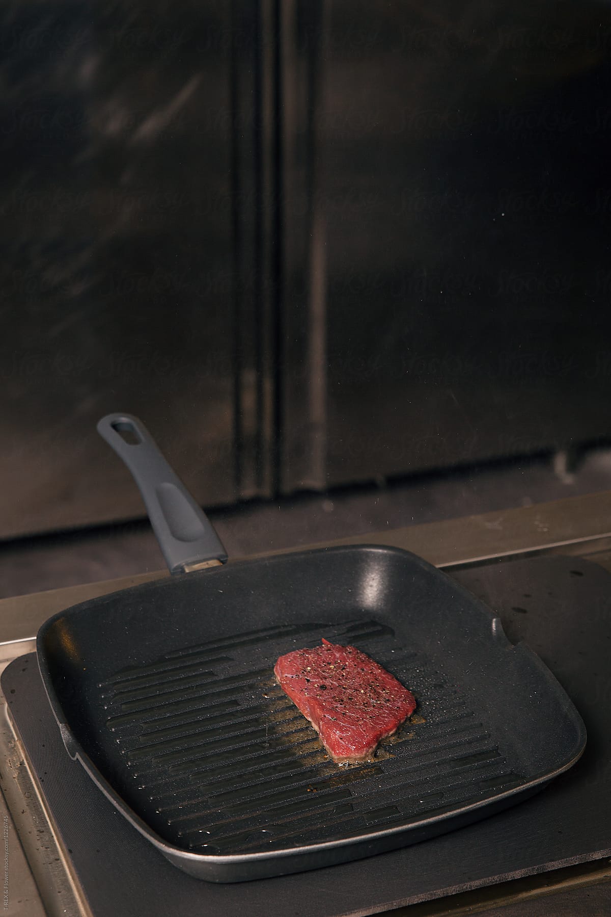 "A Steak On A Grill Pan" by Stocksy Contributor "Danil Nevsky" - Stocksy