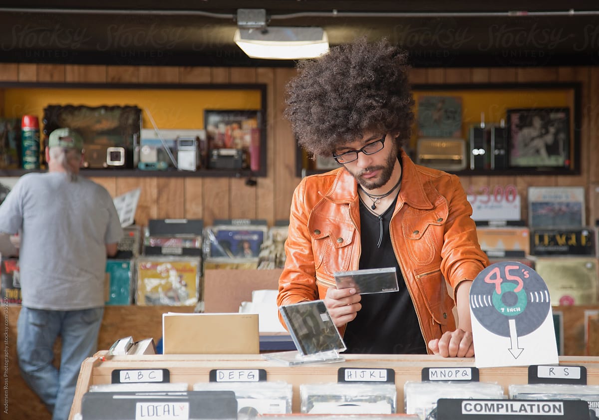 "Young Man In Record Shop" by Stocksy Contributor "Andersen Ross ...