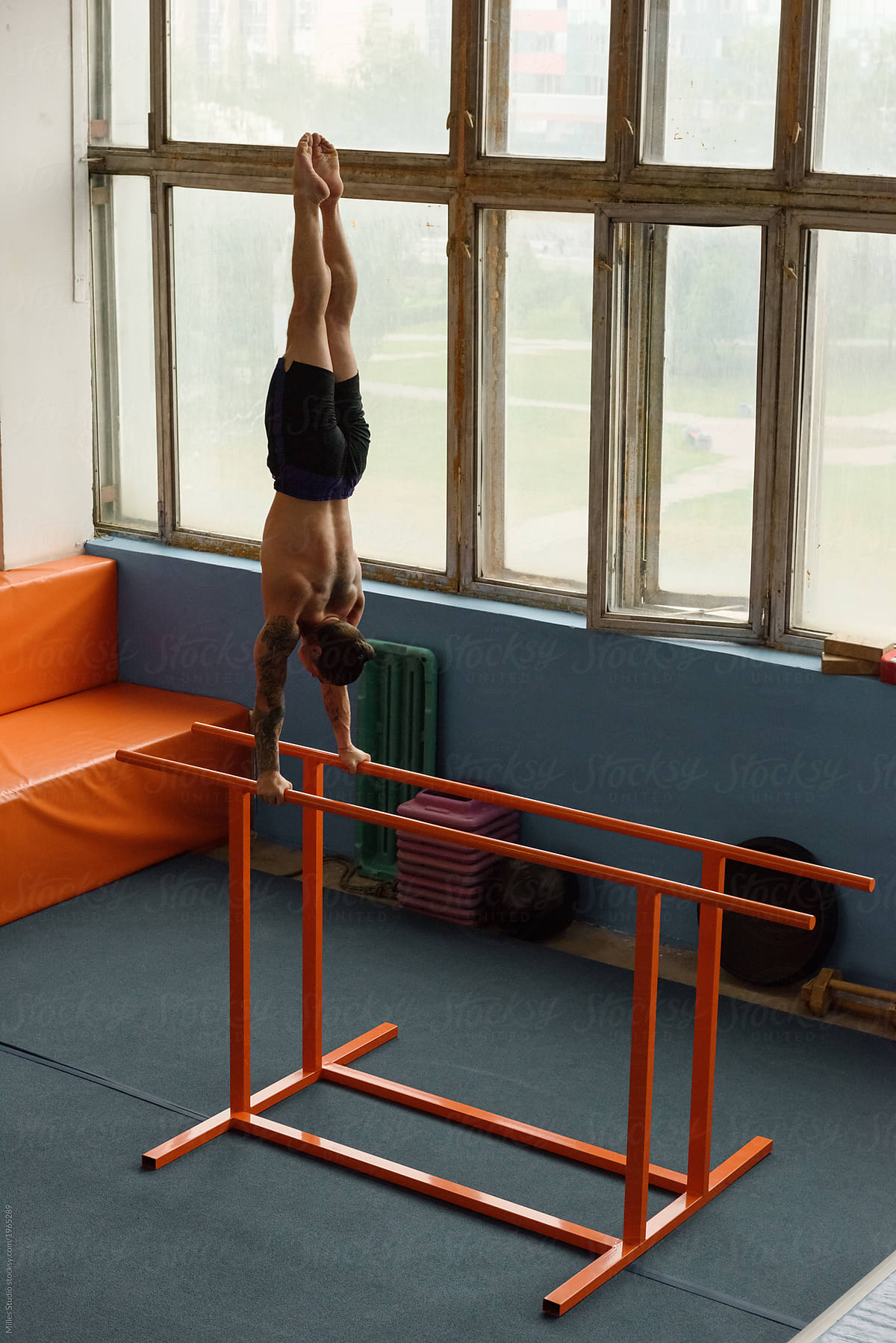 "Sportive Man Doing Handstand On Bars" by Stocksy Contributor "Milles ...