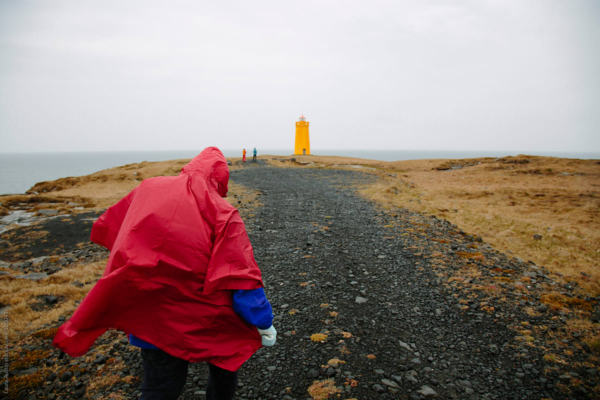 "Woman Walking Through Storm By A Lighthouse" by Stocksy Contributor ...
