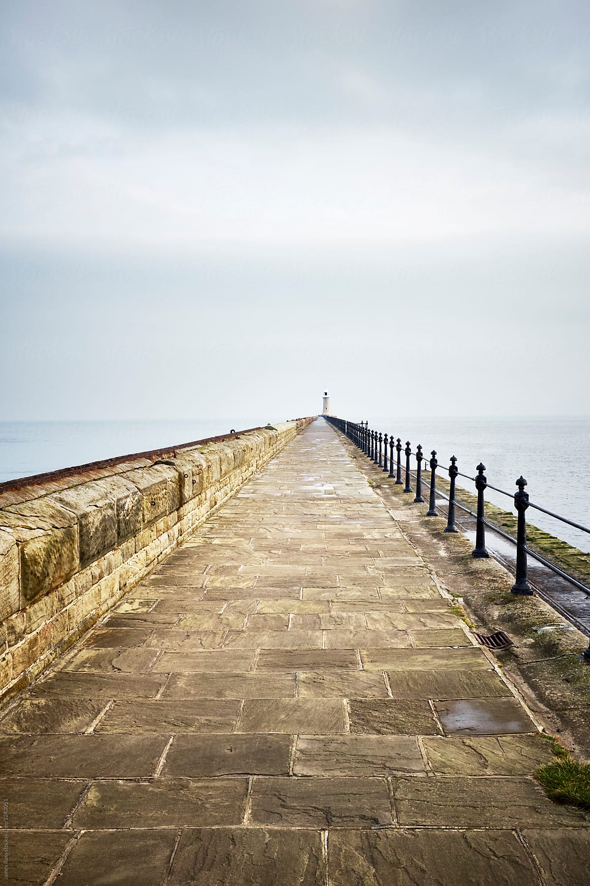 "Pier And Lighthouse" by Stocksy Contributor "James Ross" - Stocksy